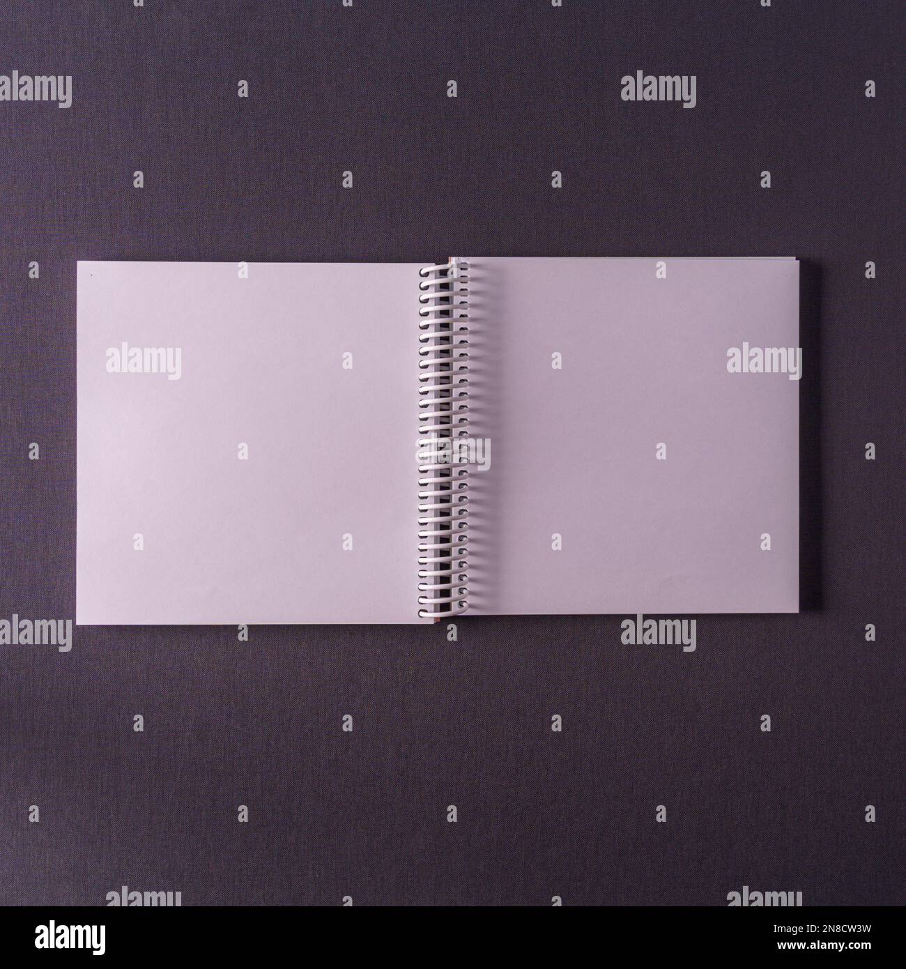 Mockup. An empty school notebook with a spiral spring in expanded form ...