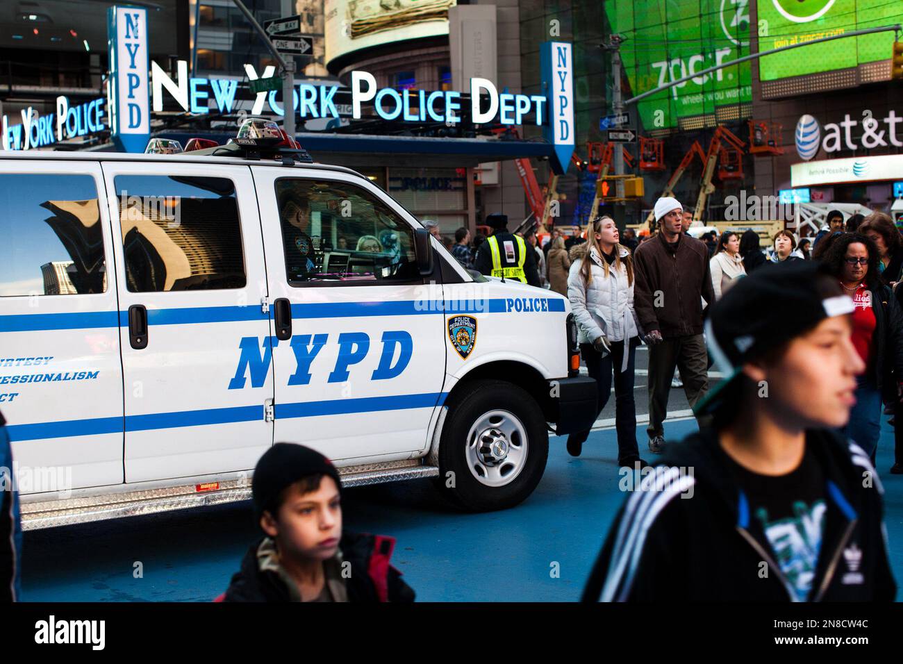 FILE - In this Dec. 31, 2011 file photo, pedestrians pass police vans ...