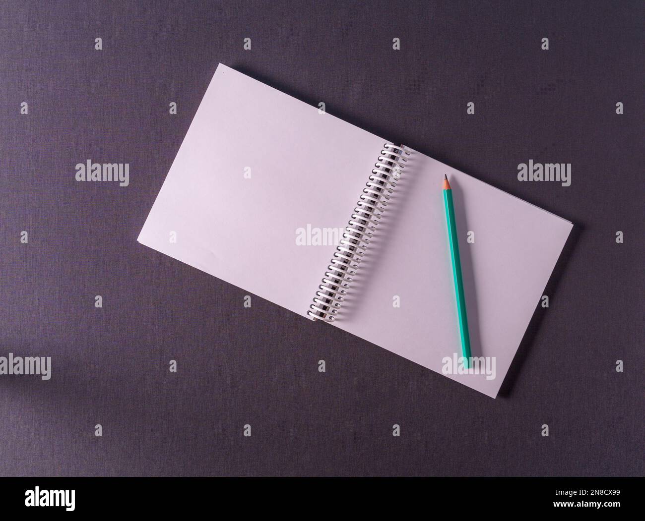 Mockup. An empty school notebook with a spiral spring in expanded form ...