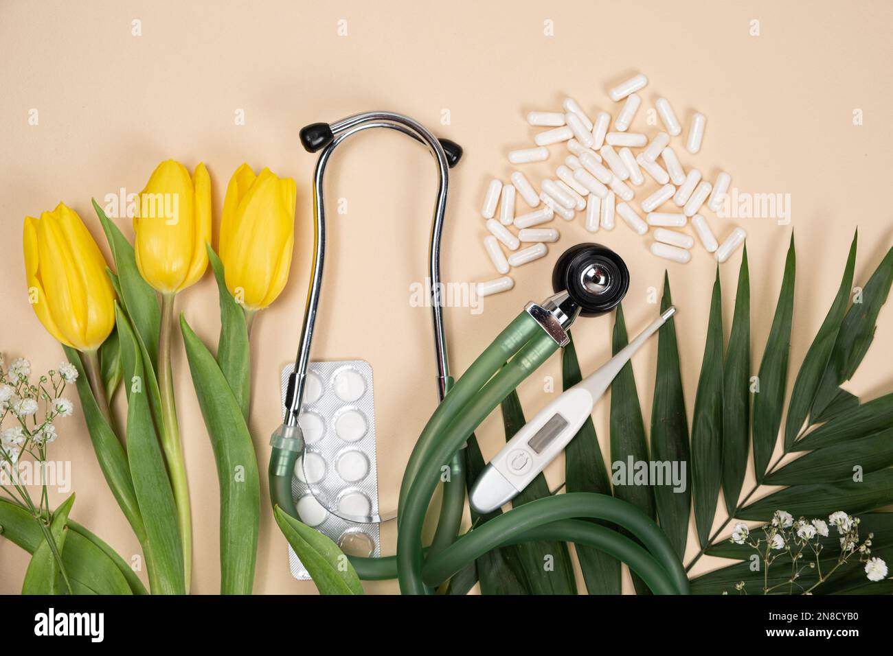 Bouquet of flowers and stethoscope on a beige background, happy doctors ...