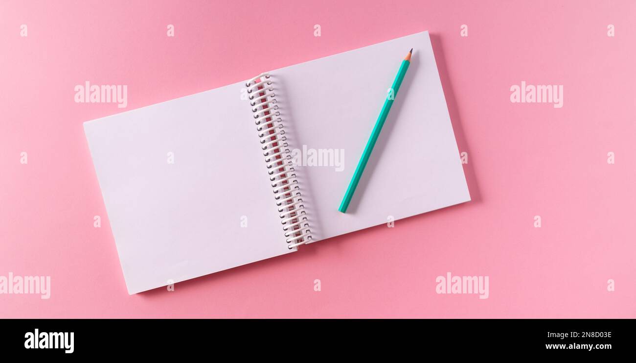 Mockup. An empty A4 notebook in expanded form on a pink paper ...