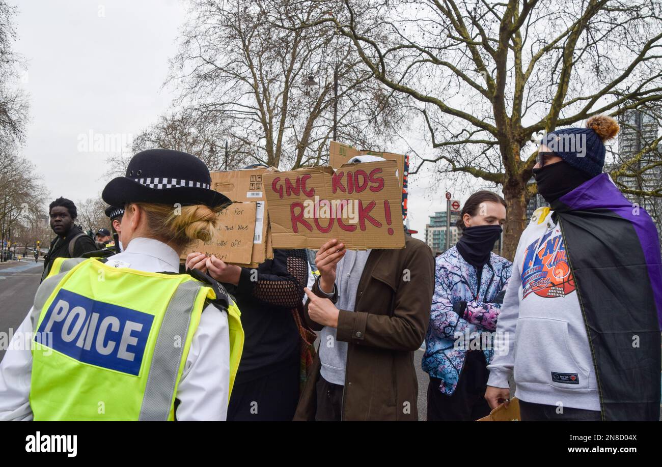 A pro-LGBTQ rights protester holds a placard which states 'Gender Non ...
