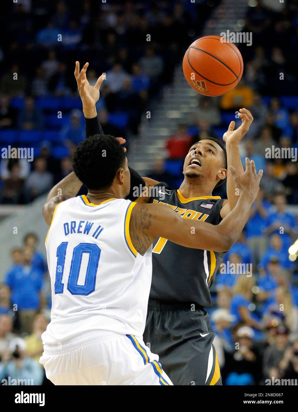 Missouri's Phil Pressey, right, and UCLA's Larry Drew II fight for a ...