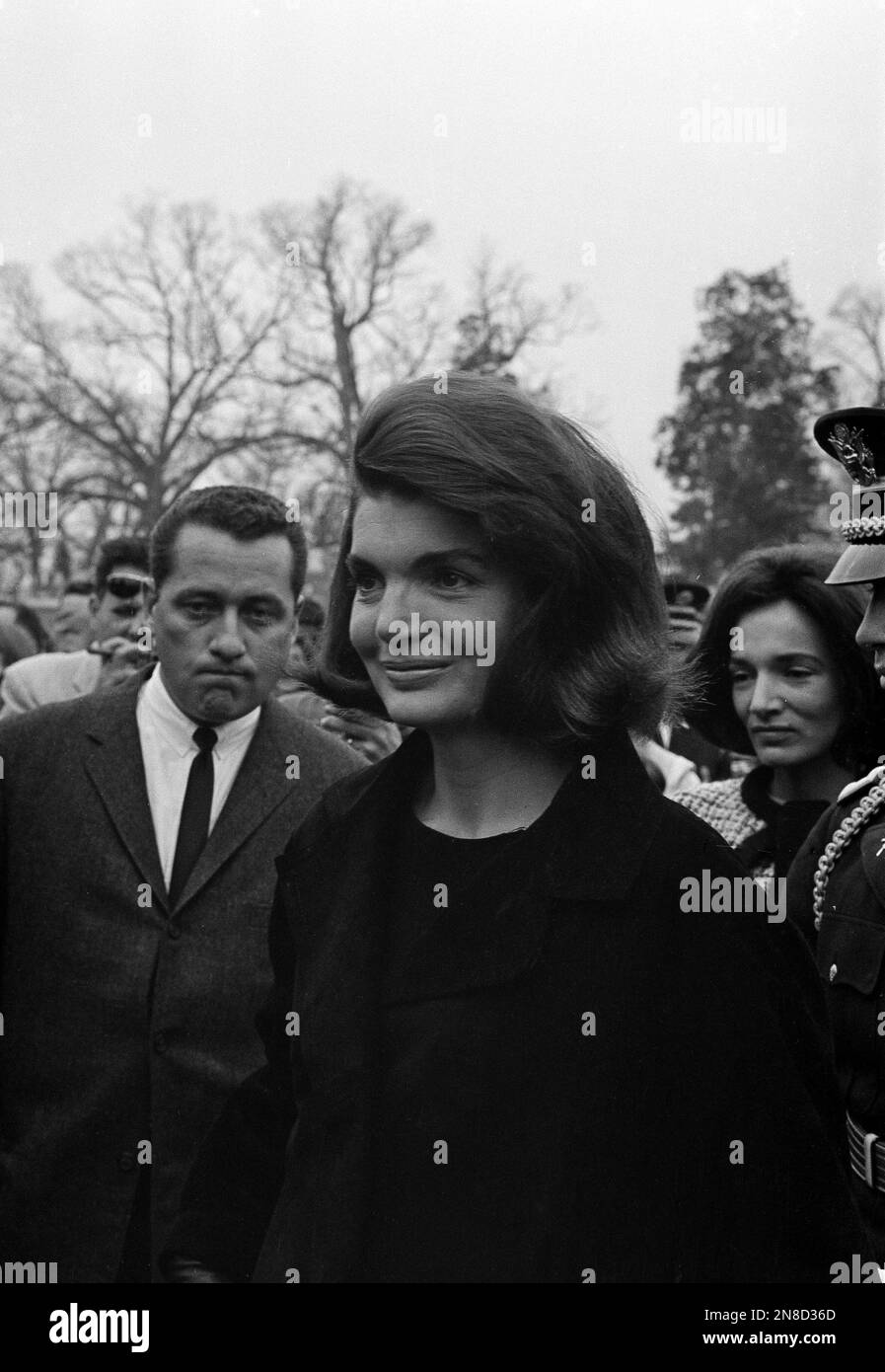 Jacqueline Kennedy manages a faint smile as she stands in Arlington ...
