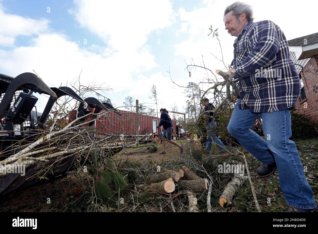 Barry Caruso, a New Orleans fire fighter, hauls a downed branch to a ...