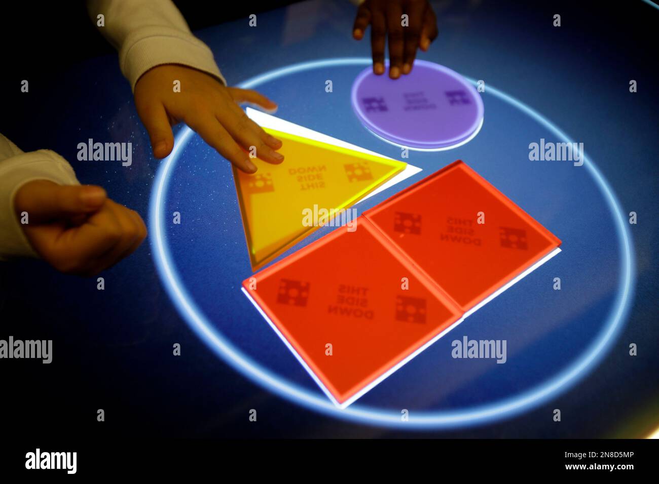 Visitors to the new National Museum of Mathematics try out an ...