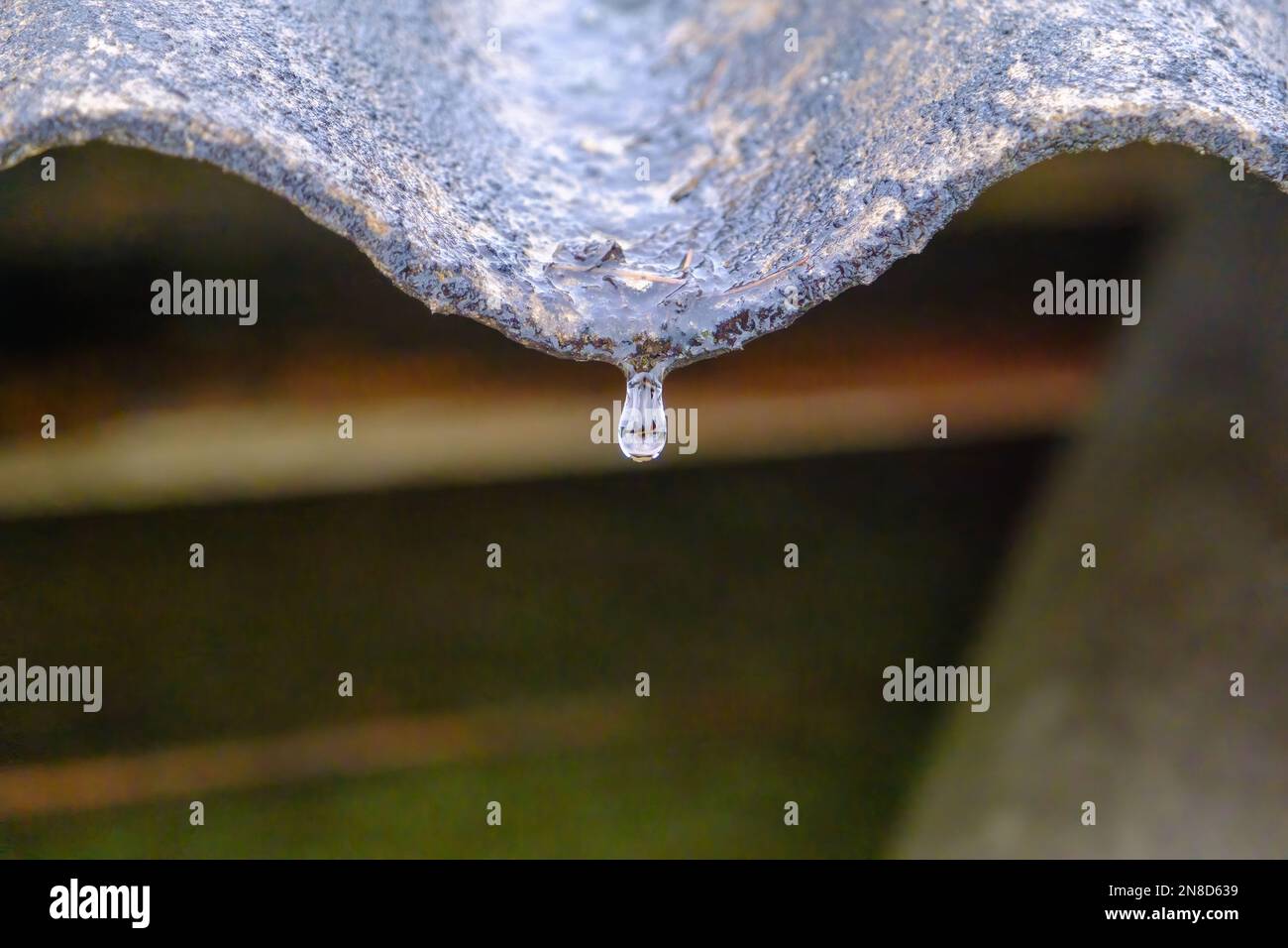 A drop of water from the edge of the roof. The beauty of winter nature ...