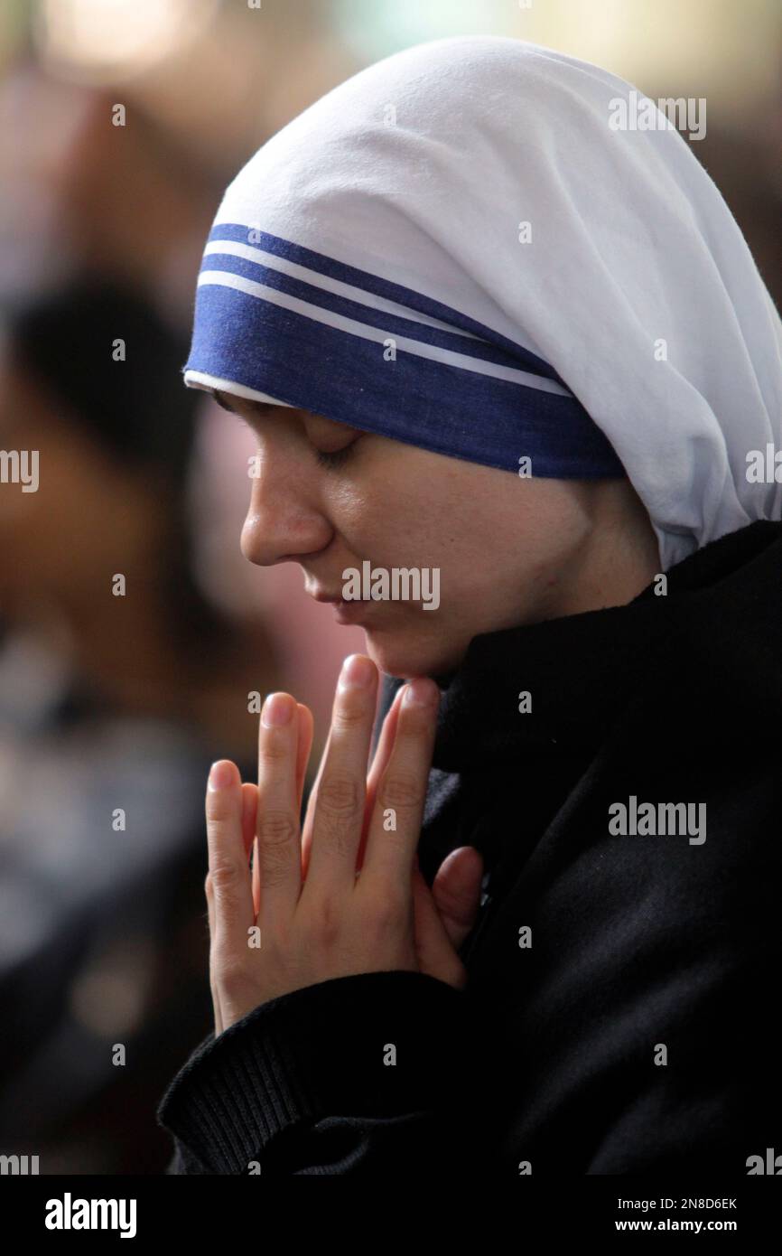 A Christian nun prays during a Christmas mass at a Catholic Church in ...