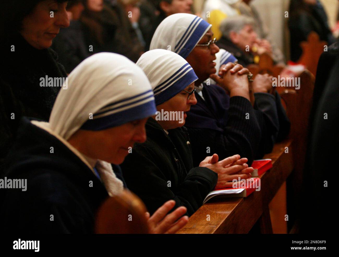 Nuns and worshipers pray during mass in at the Church of the Nativity ...
