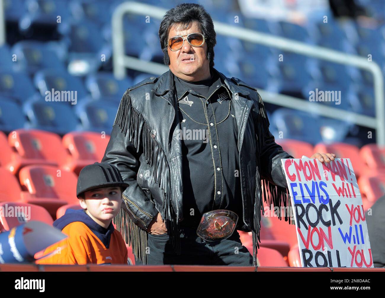 A Denver Broncos fan dressed as Elvis watches warmups before of an NFL ...
