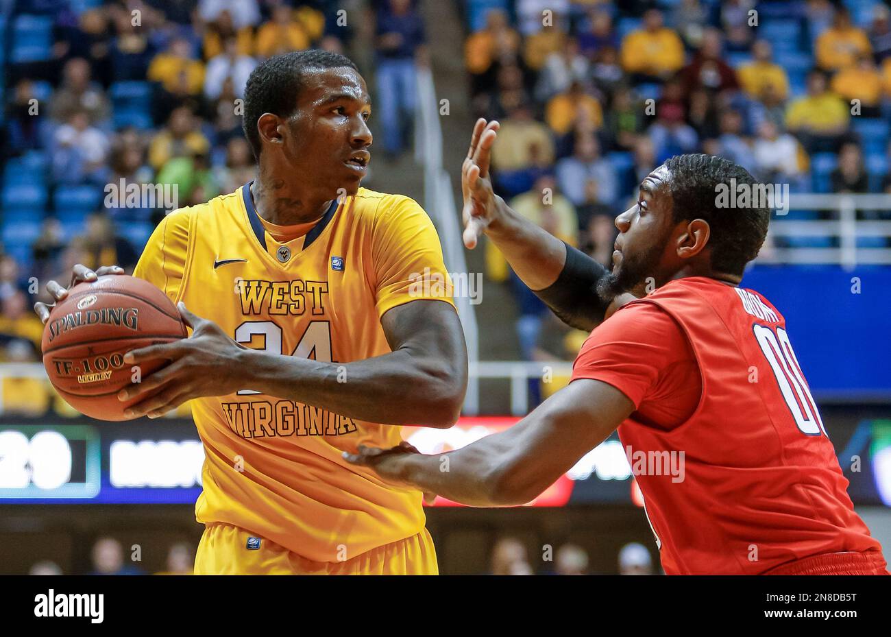 West Virginia's Aaric Murray (24) is defended by Radford's Kion Brown ...