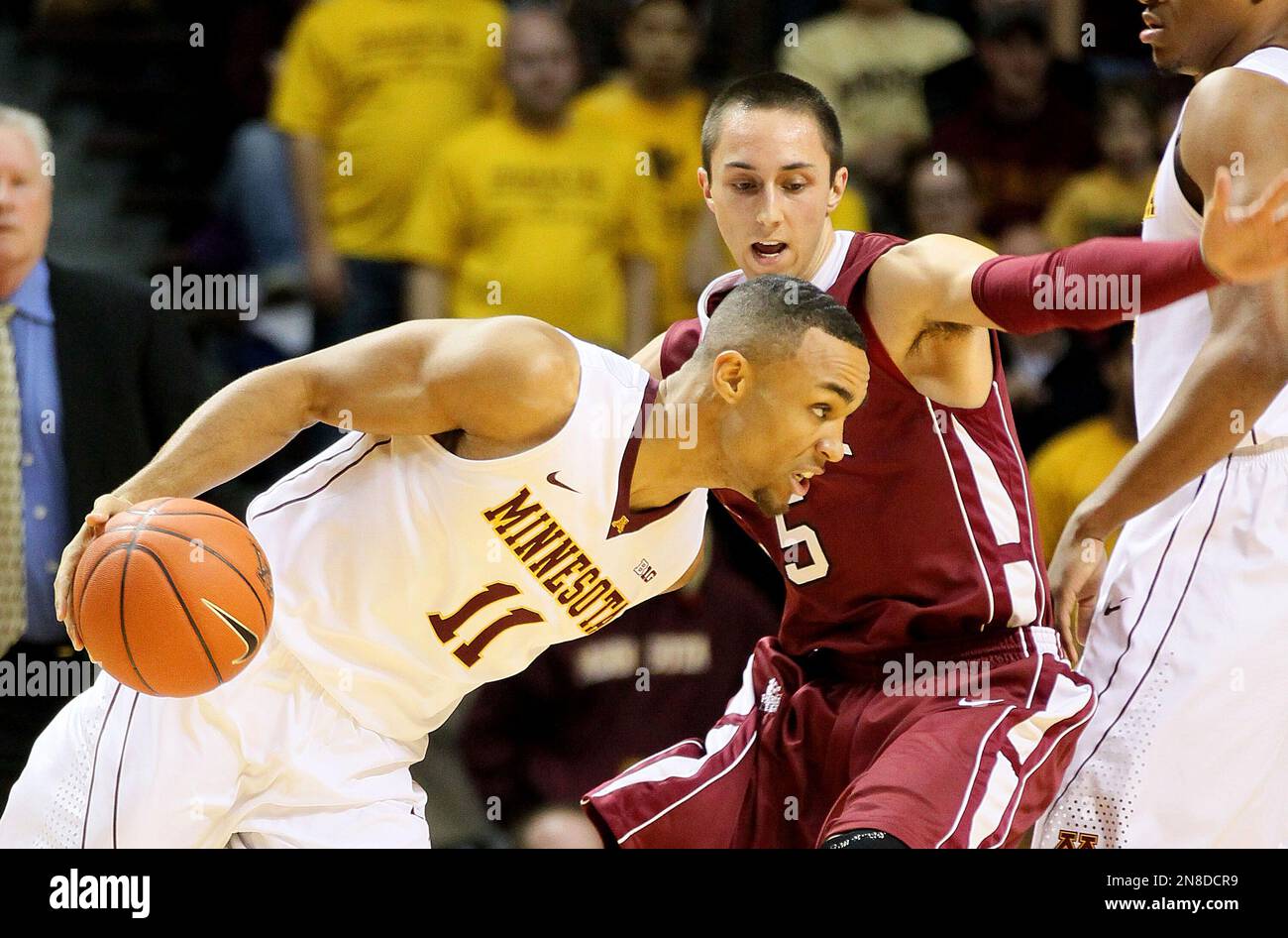 Minnesota guard Joe Coleman (11) drives on Lafayette guard Joey ...