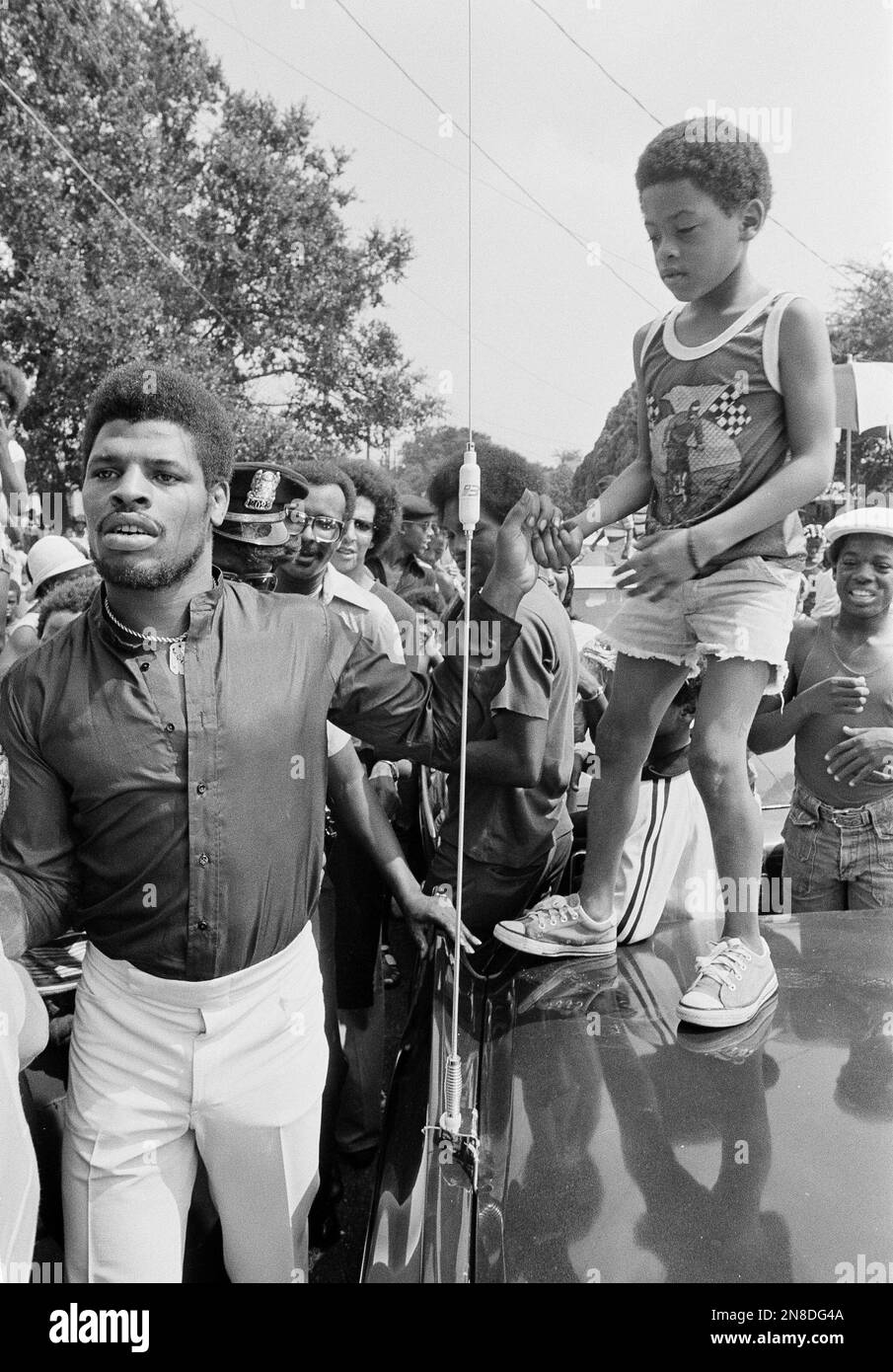 Heavyweight champion Leon Spinks reaches out to shake hands during a ...