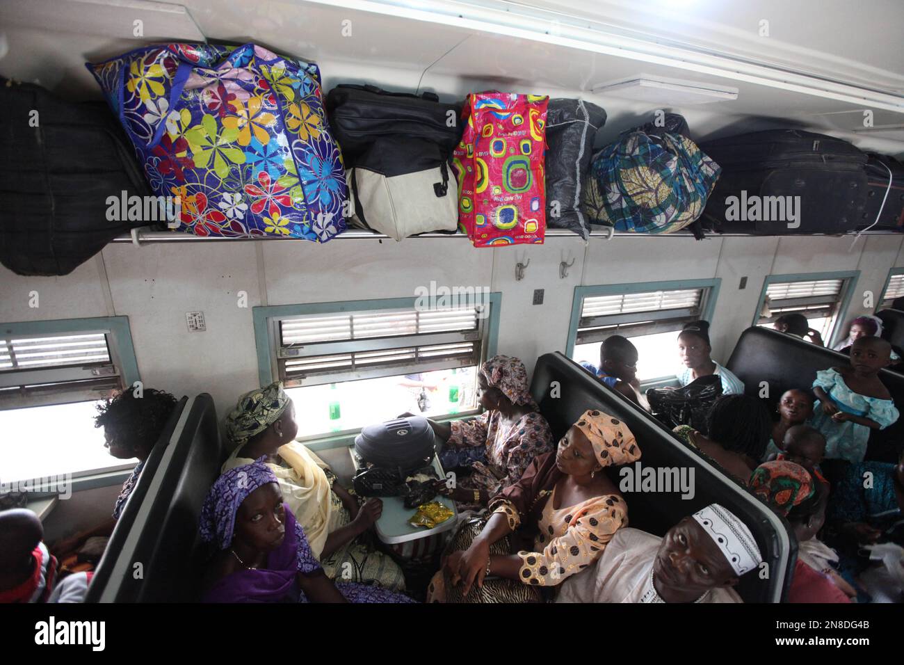 Passengers traveling to Kano are seated inside an inaugural train in ...