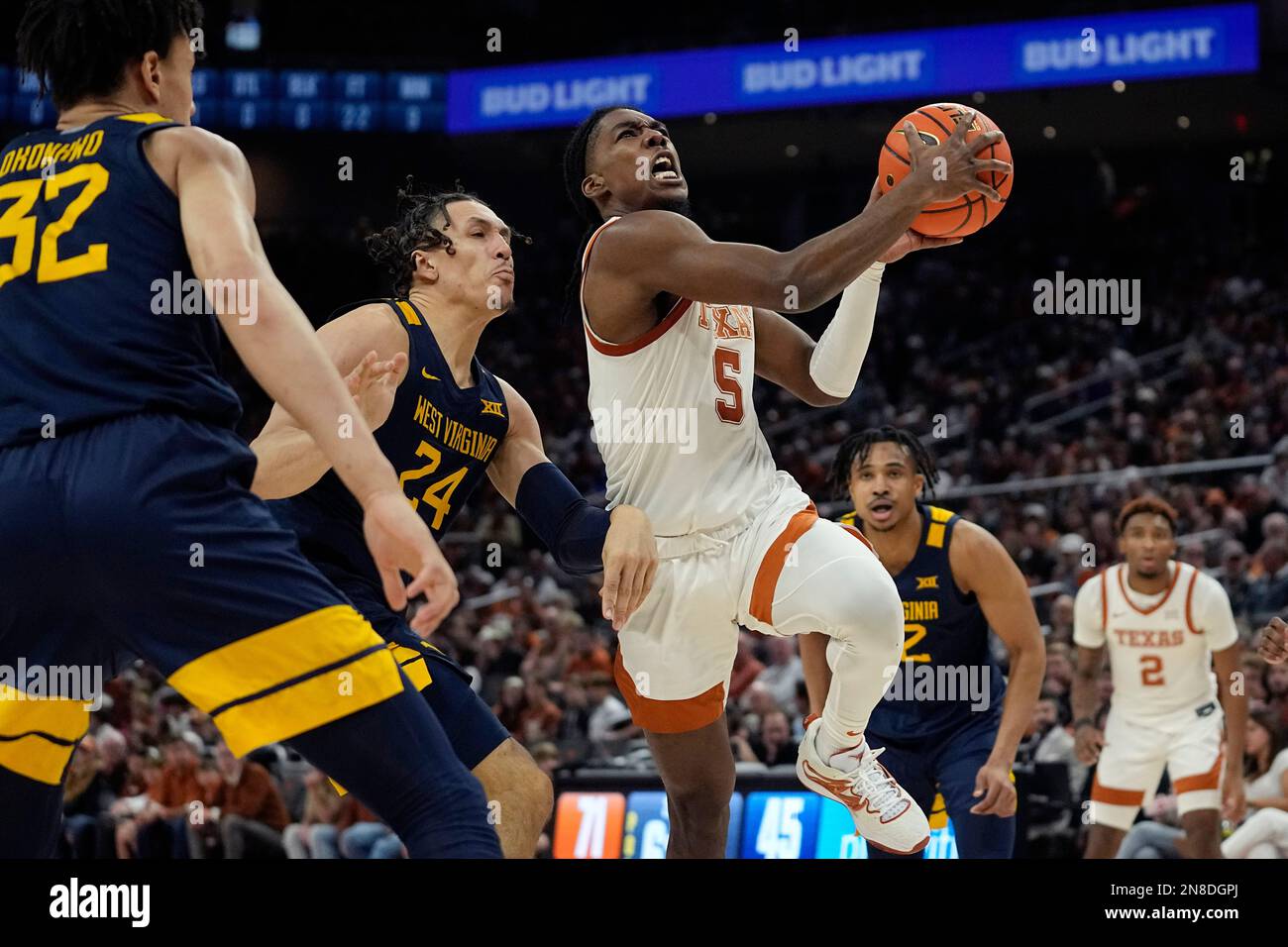 Texas guard Marcus Carr (5) drives to the basket past West Virginia ...