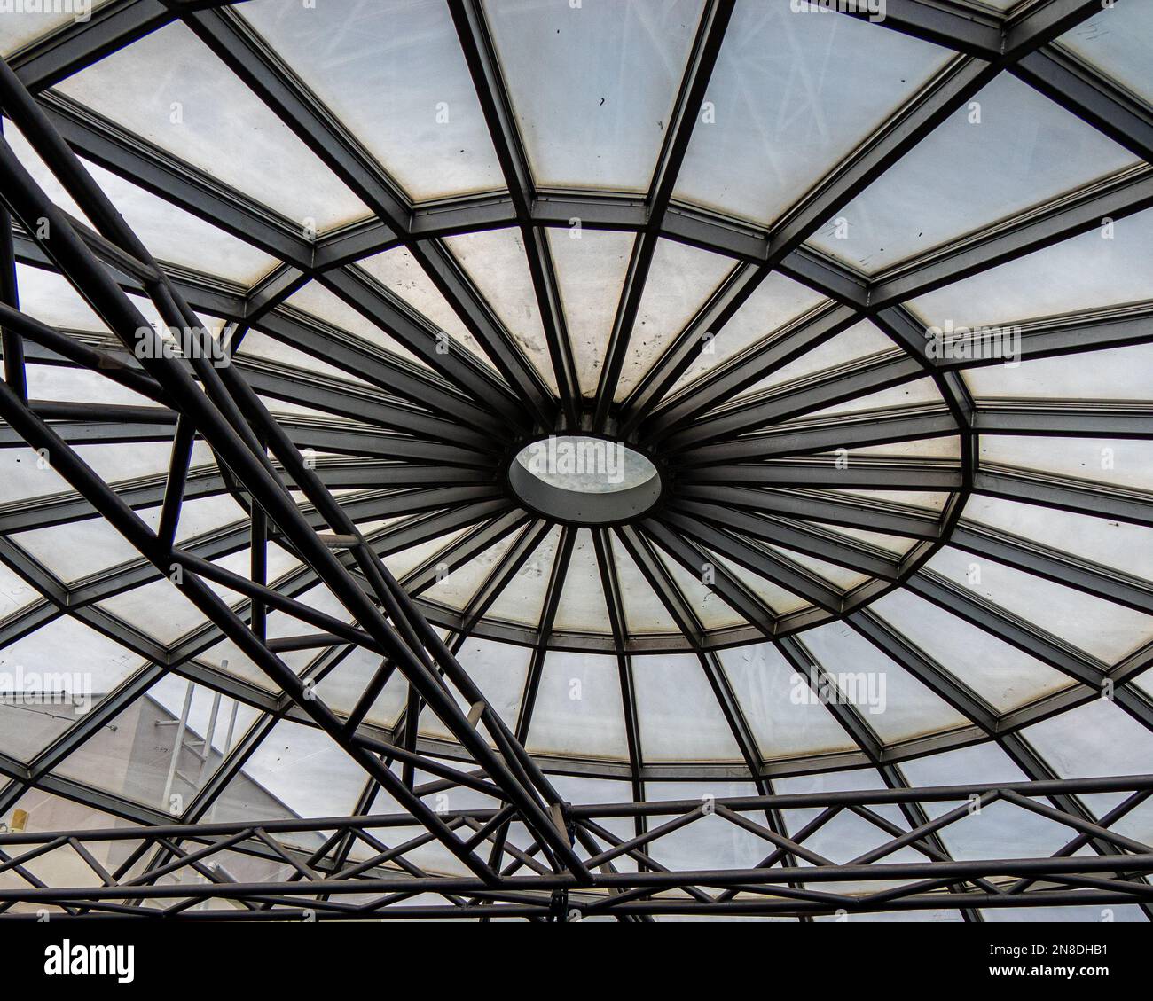 A decorated metal roof with circle and round design and glass ceiling ...