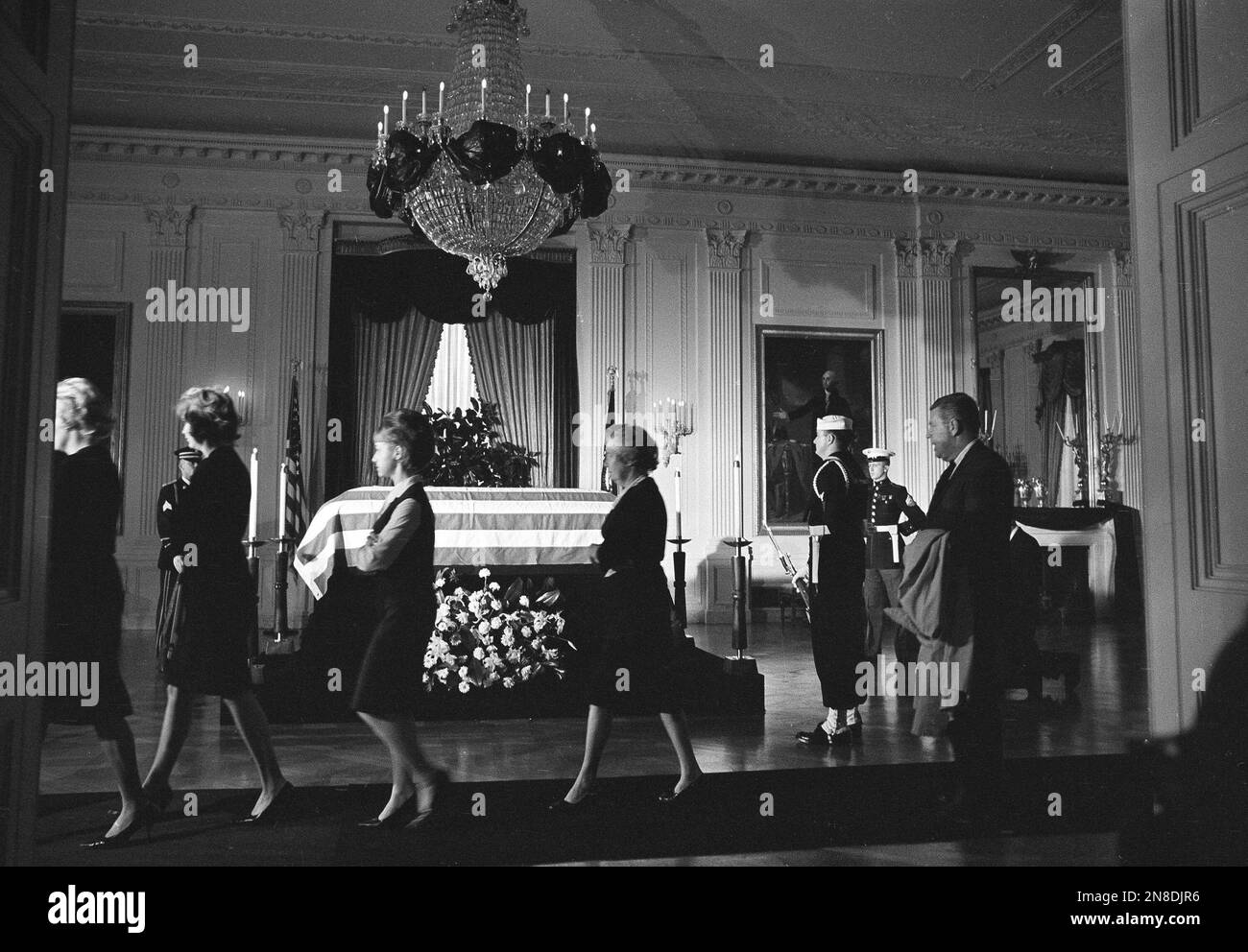 Members of the White House staff file past the body of John F. Kennedy ...