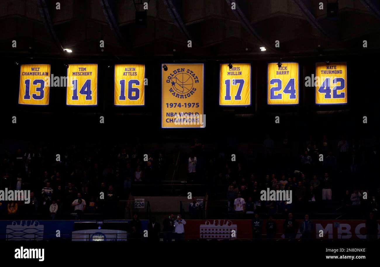 Retired jerseys of former Golden State Warriors players hand from the ...
