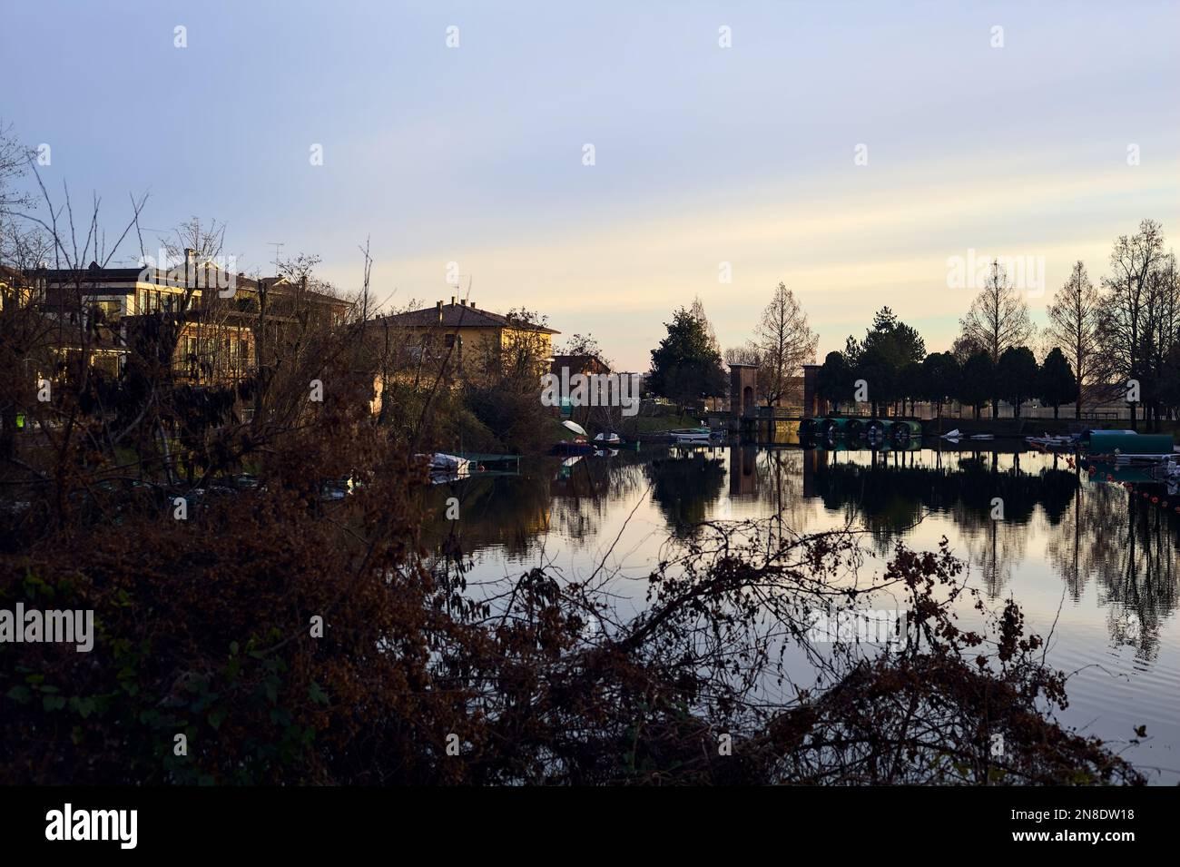 Pier in an inlet of a lake with the sky casted in the water framed by ...