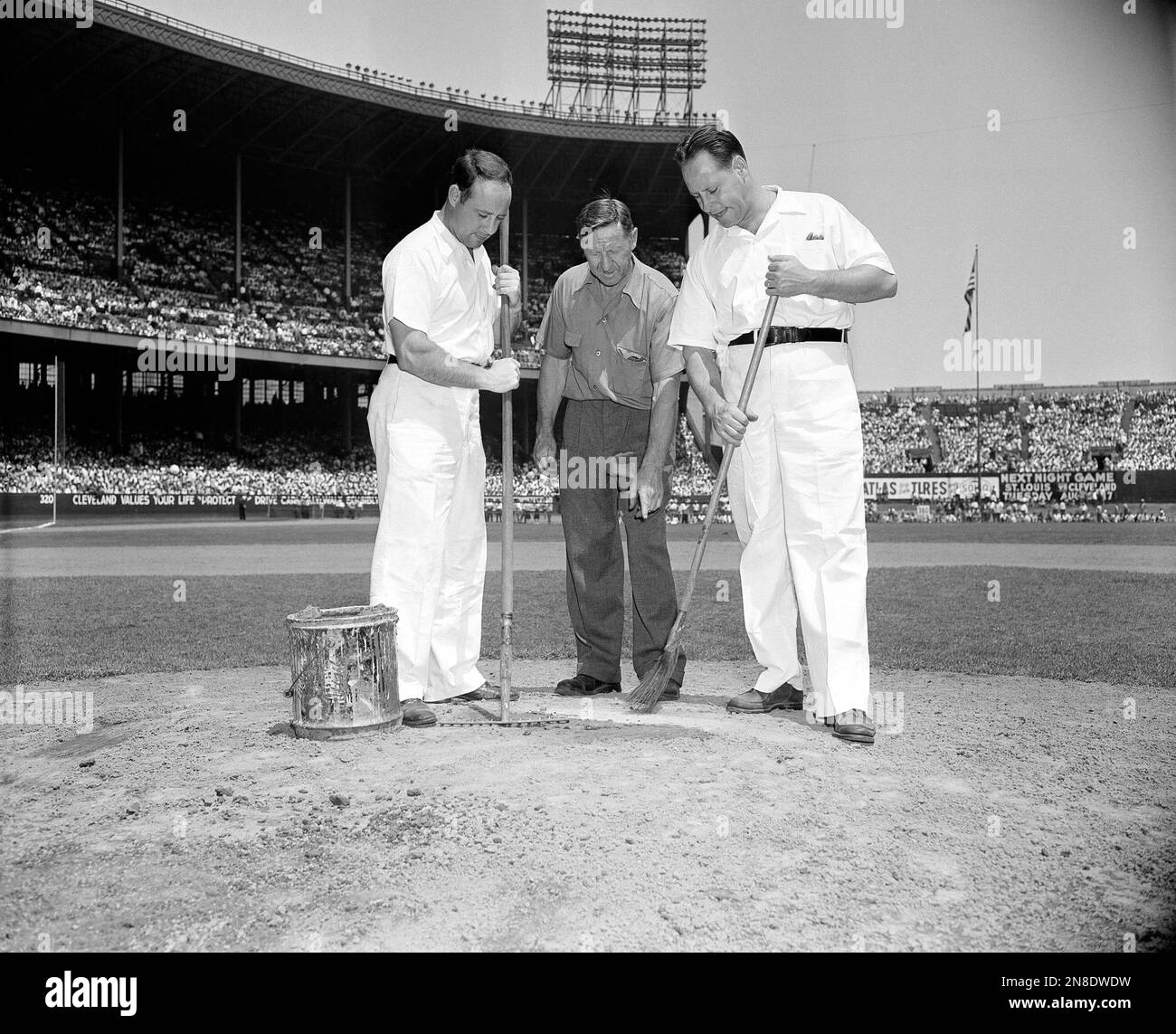 Emil Bossard and his two sons, Harold, left, and Marshall, work on the ...