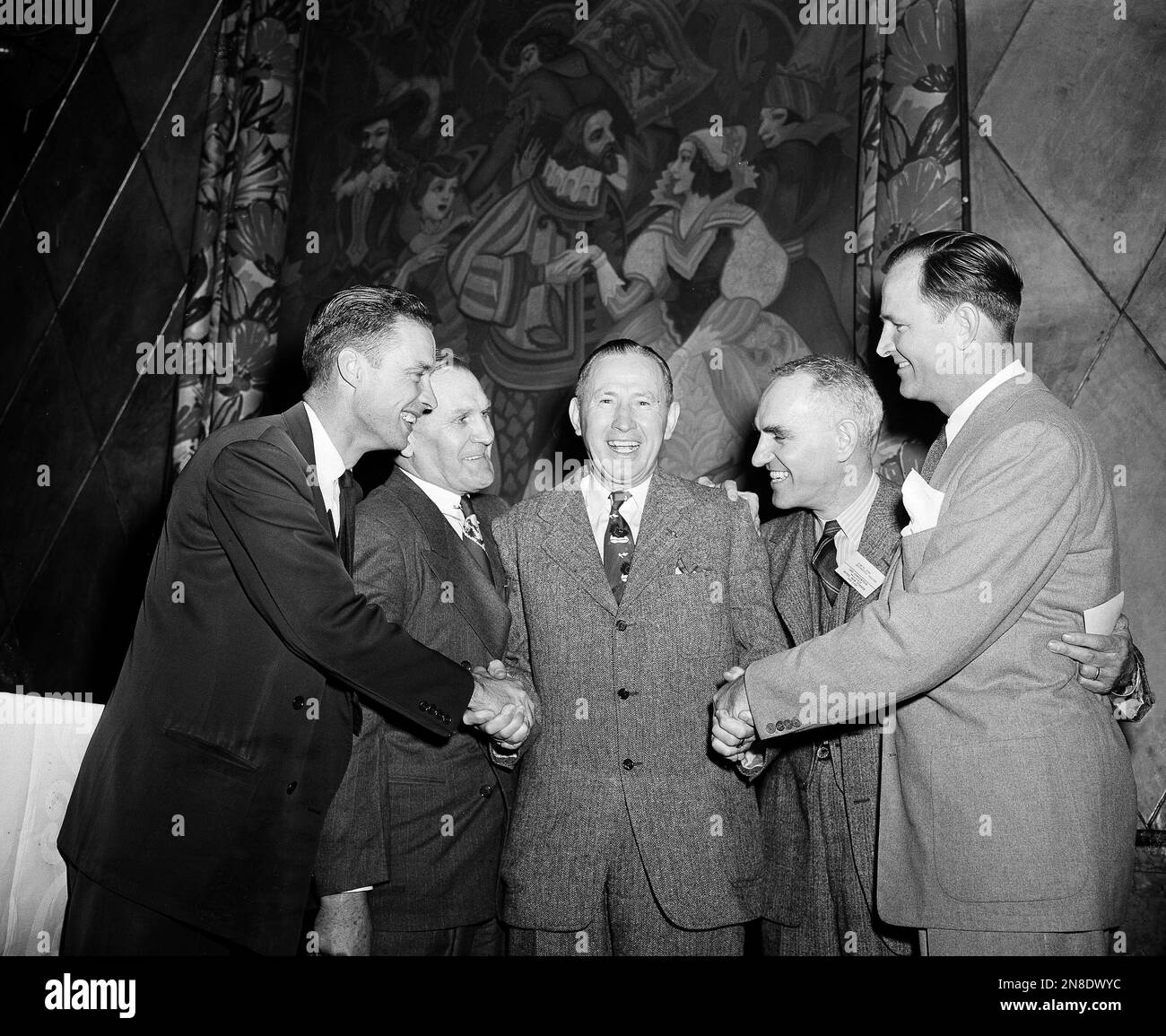 University of Kansas coach Forrest C. "Phog" Allen, center, gets ...