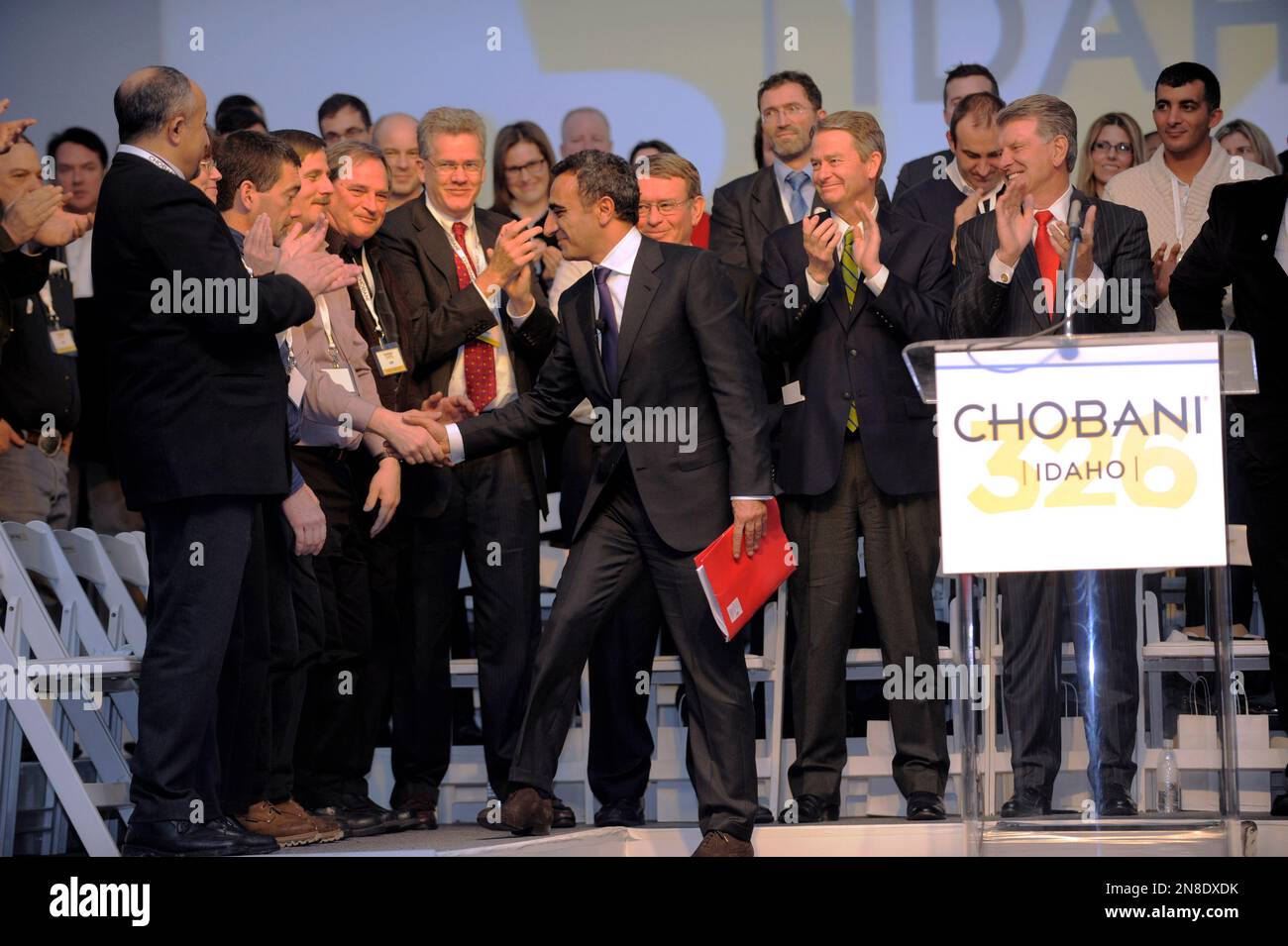 Hamdi Ulukaya, founder and chief executive officer of Chobani, shakes ...