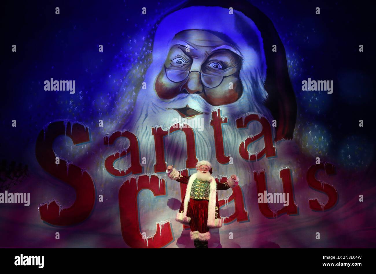 A performer, from Britain, dressed as Santa Claus dances on stage ...