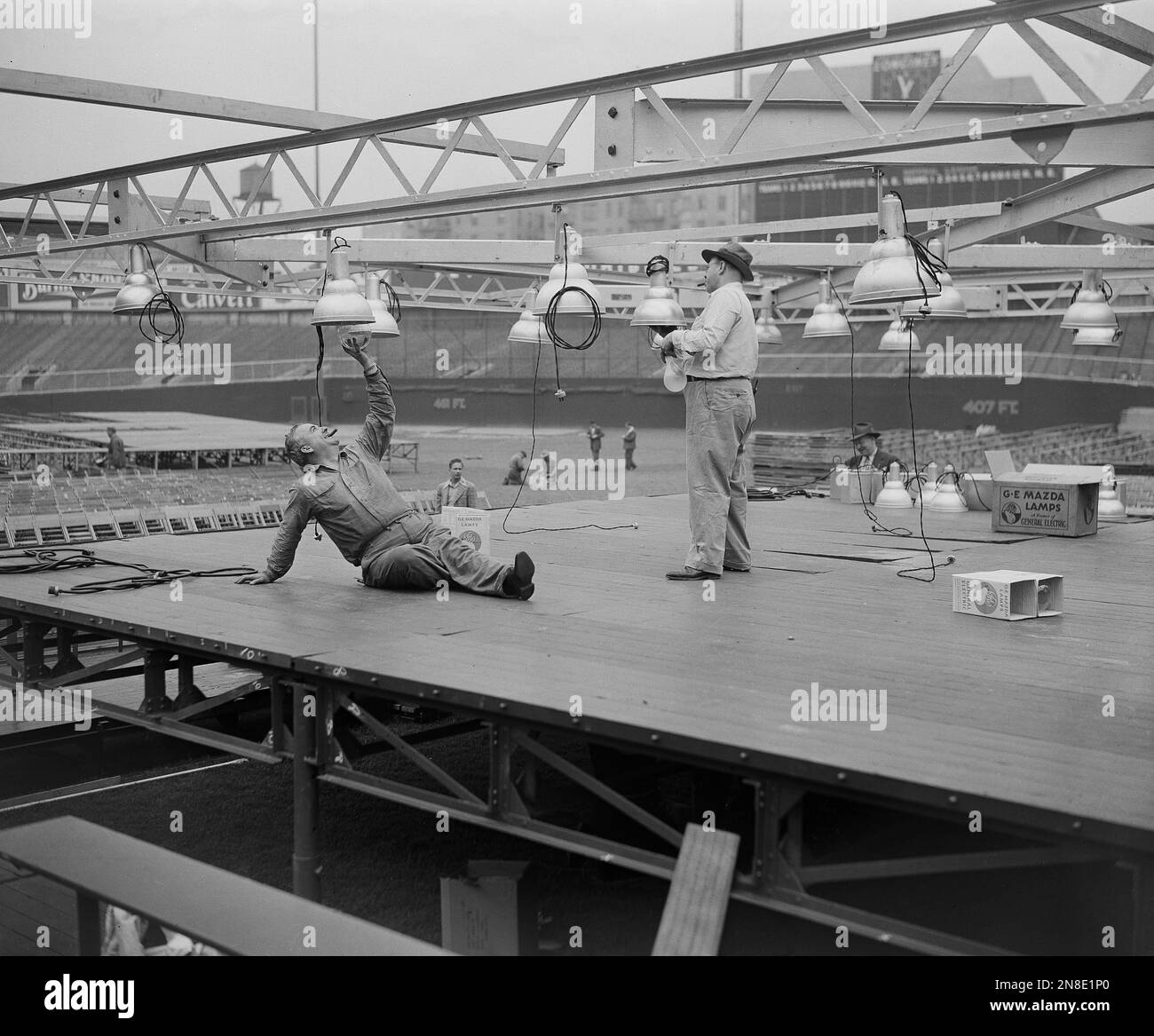 Workers install fixtures at New York's Yankee Stadium, June 17, 1946 ...