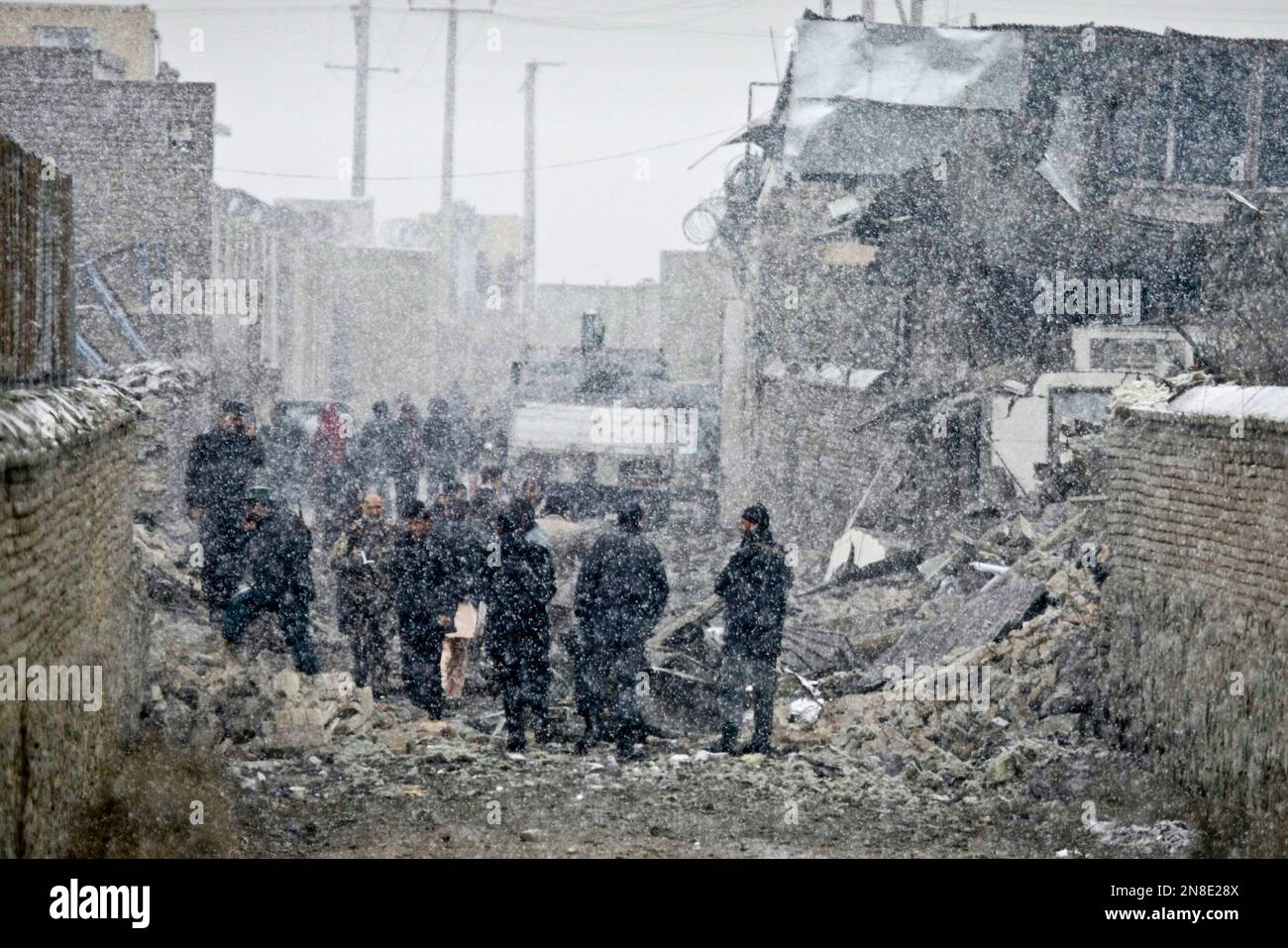 Afghan security men inspect the scene of a car bomb explosion in Kabul ...