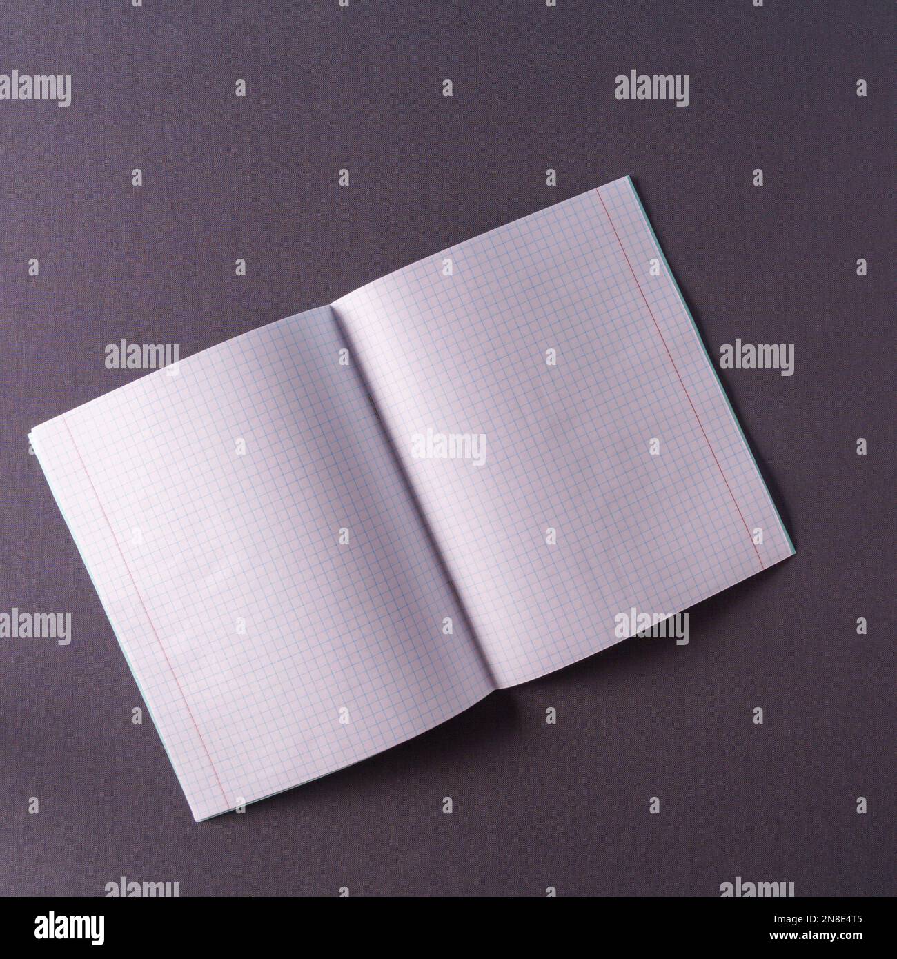 Mockup. An empty A4 notebook in expanded form on gray background, and ...