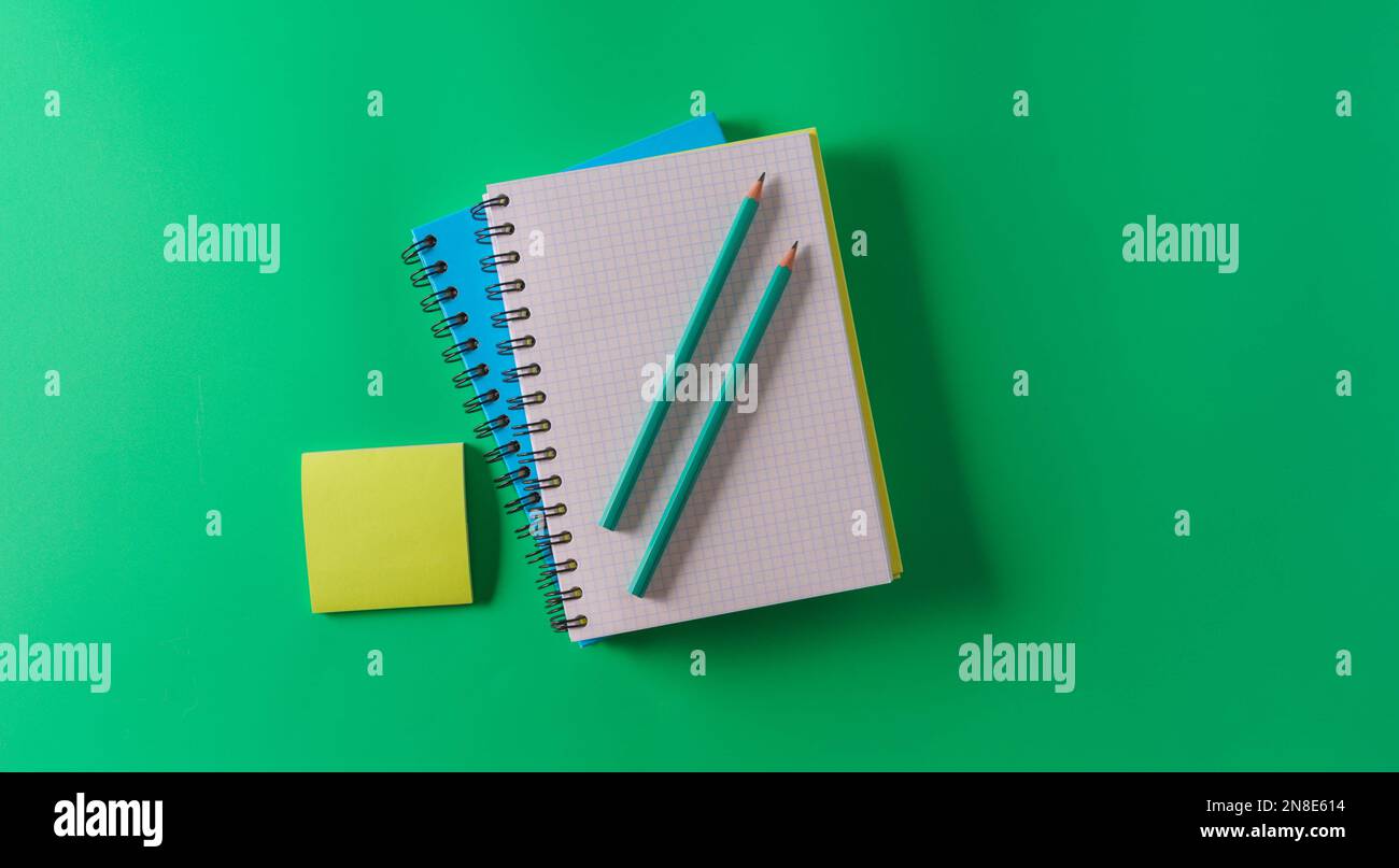 Mockup. An empty A4 notebook with a spiral spring ,pencils and stickers ...