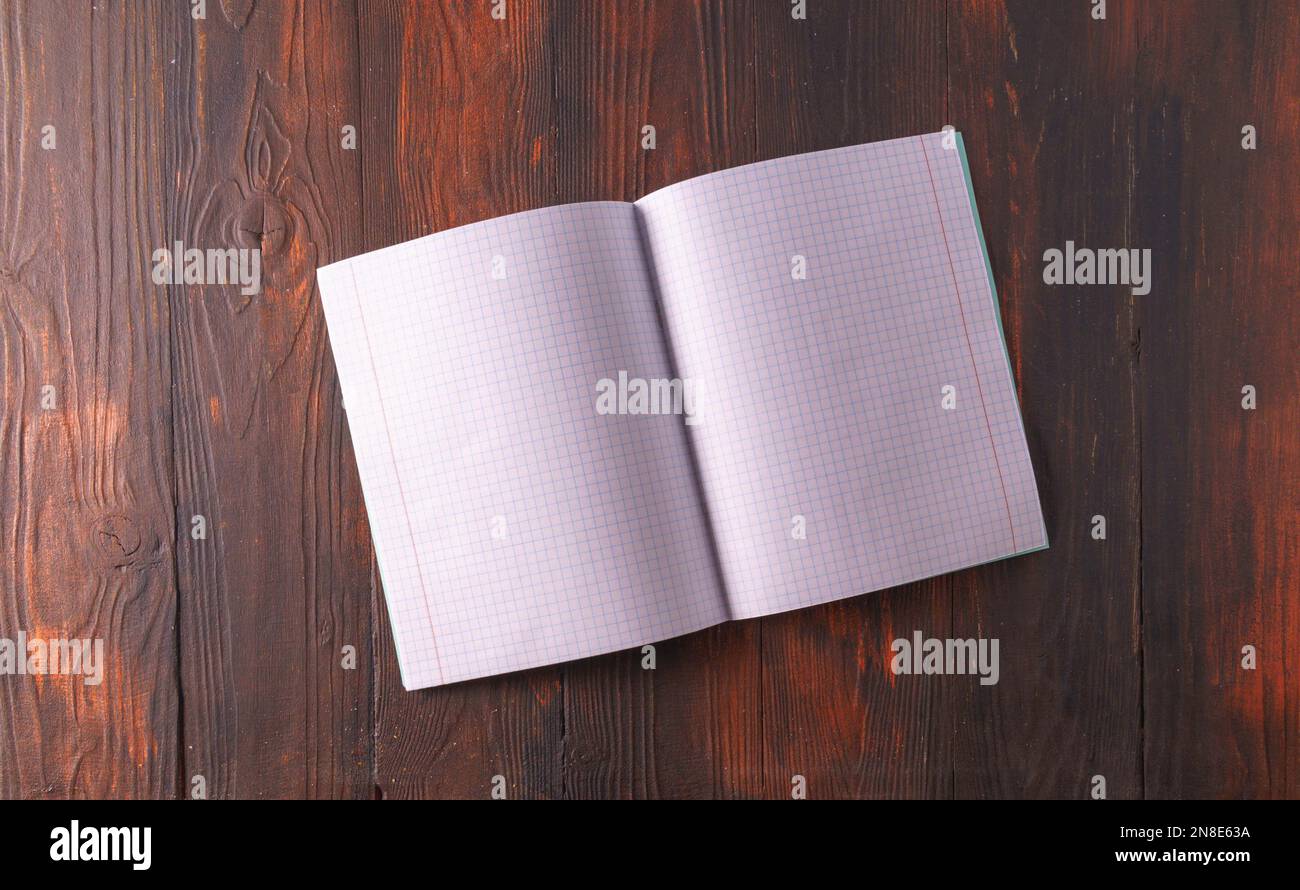 Mockup. An empty A4 notebook in expanded form on wooden background,top ...
