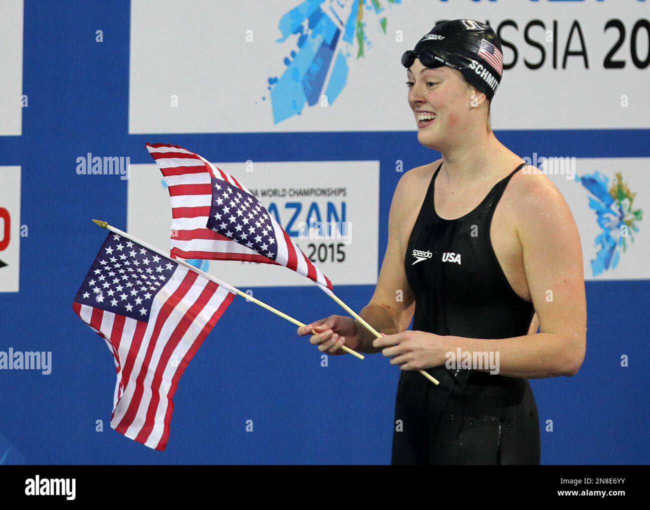 Winner Allison Schmitt of U.S. waves flags of her country after women's ...