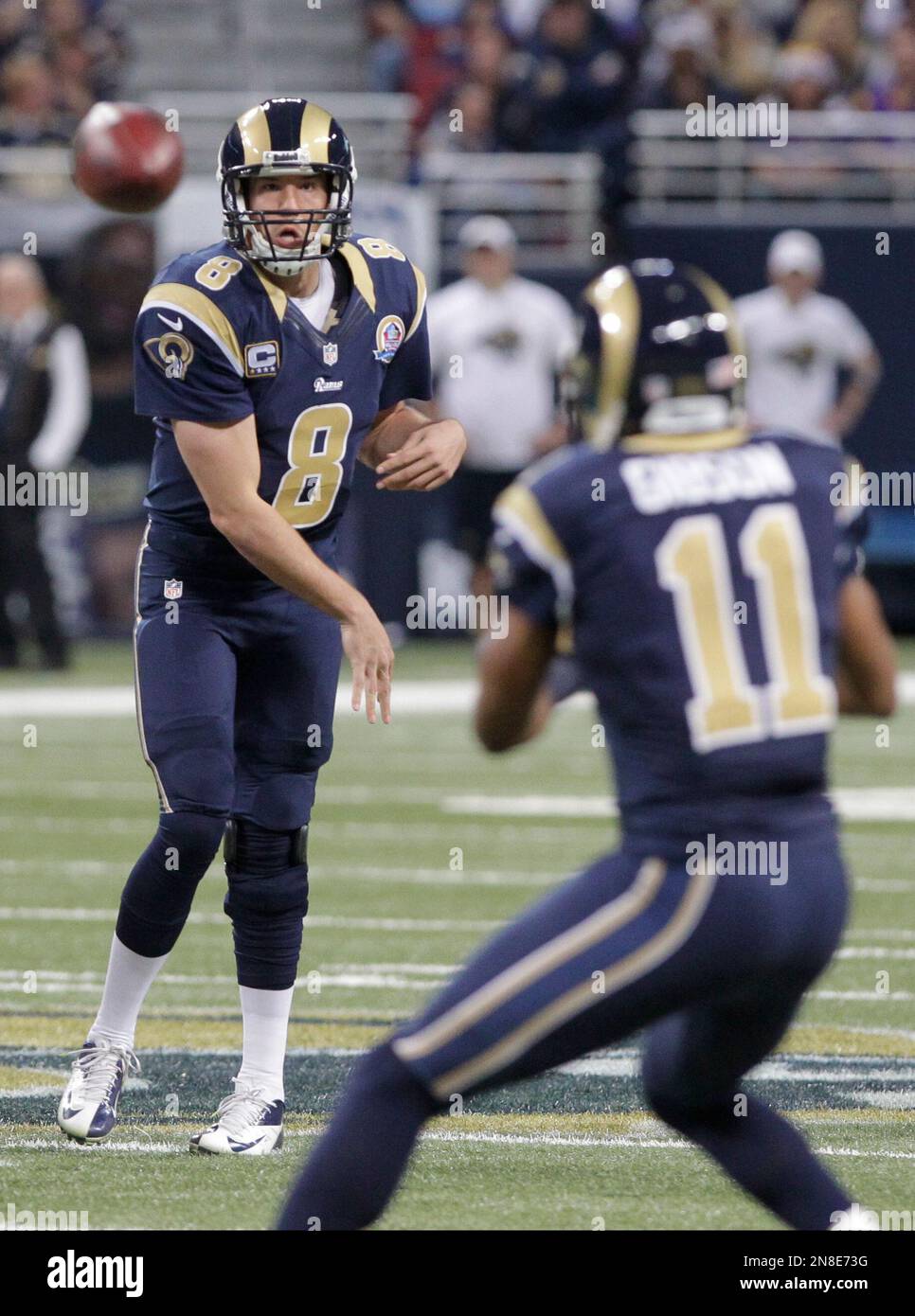 St. Louis Rams quarterback Sam Bradford, left, throws to wide receiver ...