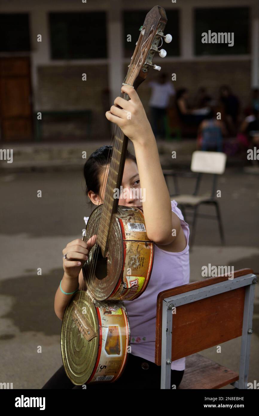 In this Dec. 11, 2012 photo, Noelia Rios, 12, tunes her guitar made of ...