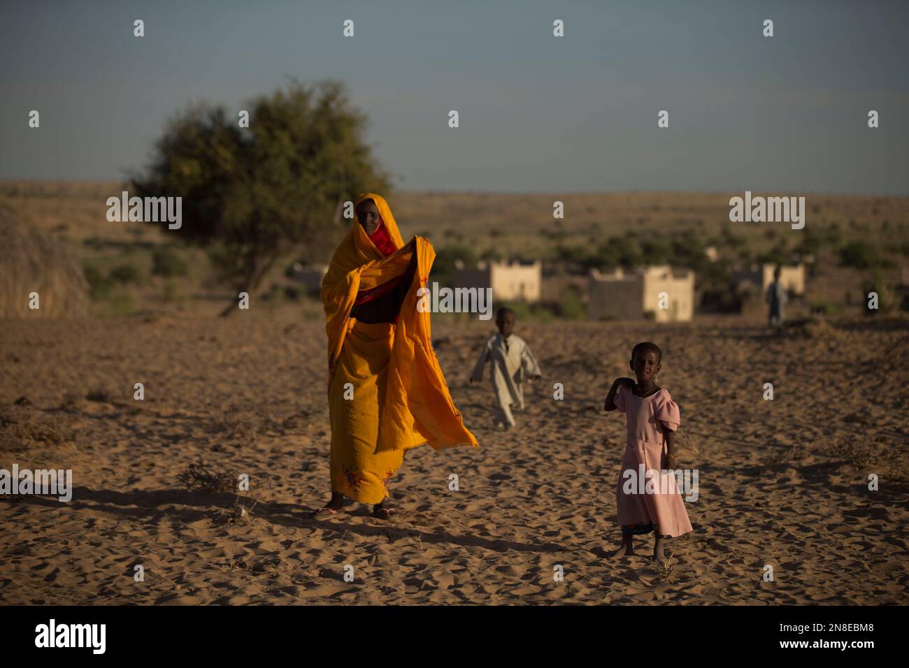 In this Nov. 1, 2012 photo, 7-year-old Achta, right, walks with her ...