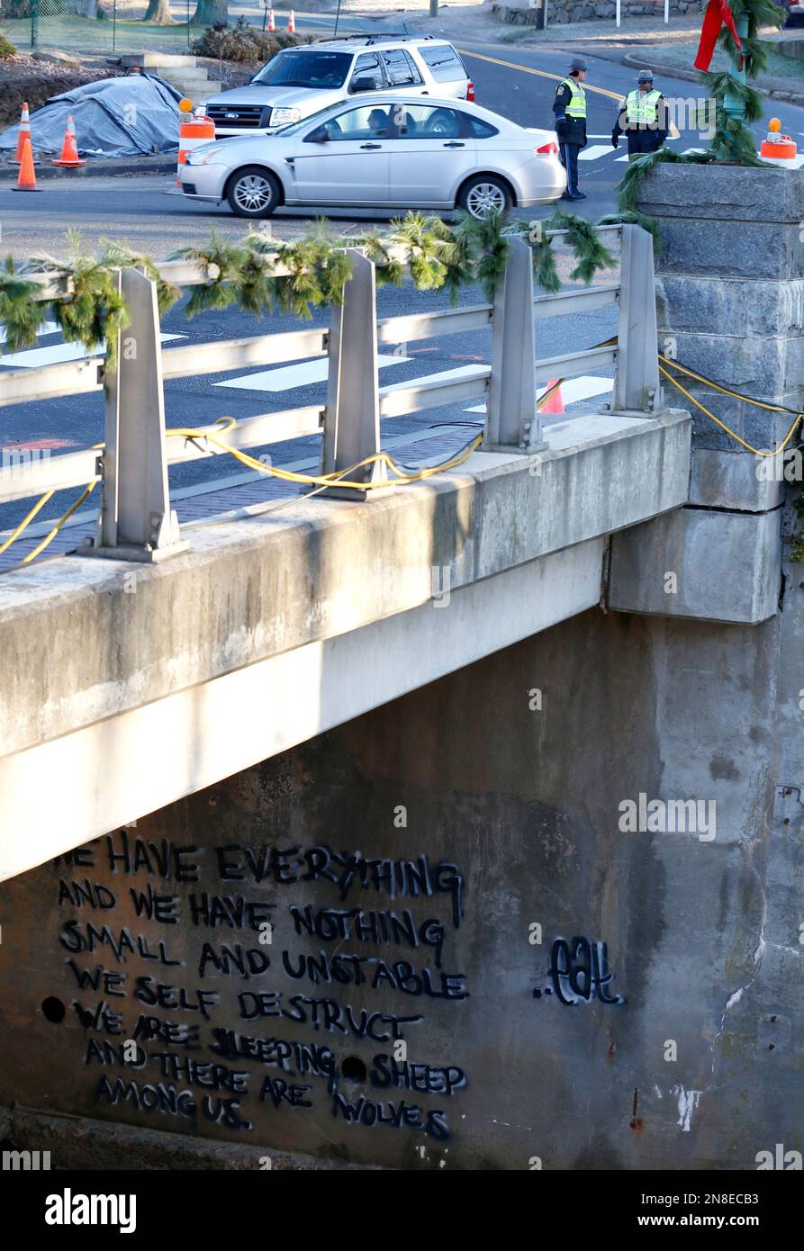 A message is written on the wall of an underpass near a creek in ...