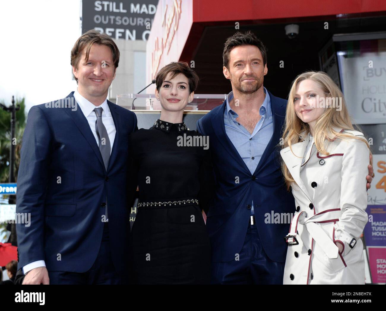 From left to right, director Tom Hooper, actress Anne Hathaway, actor ...