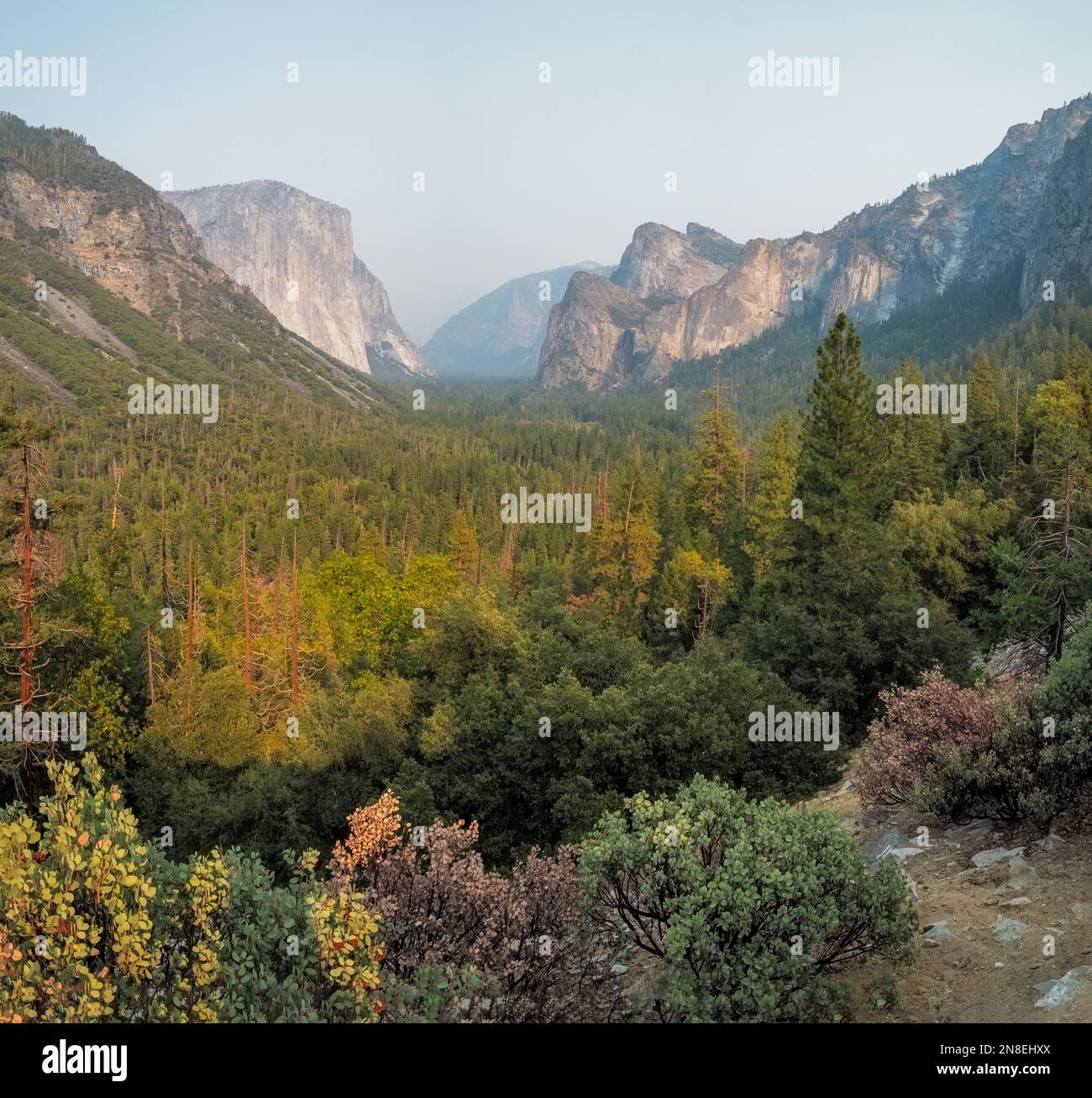 Panoramic view of Tunnel View with some smoke between the mountains, in ...