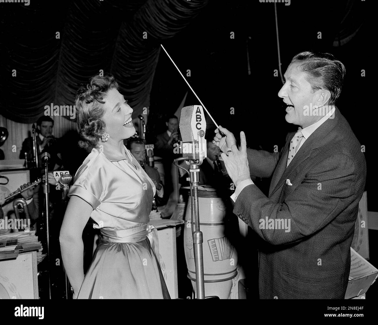 Lawrence Welk leads his orchestra and his "Champagne Lady" Alice Lon ...