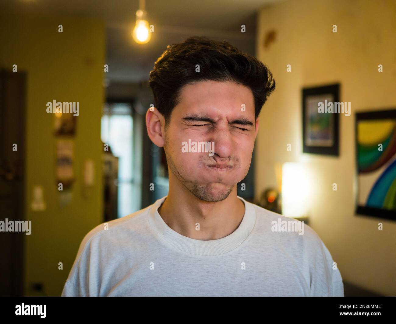 Young man with puffed cheeks, holding breath Stock Photo - Alamy