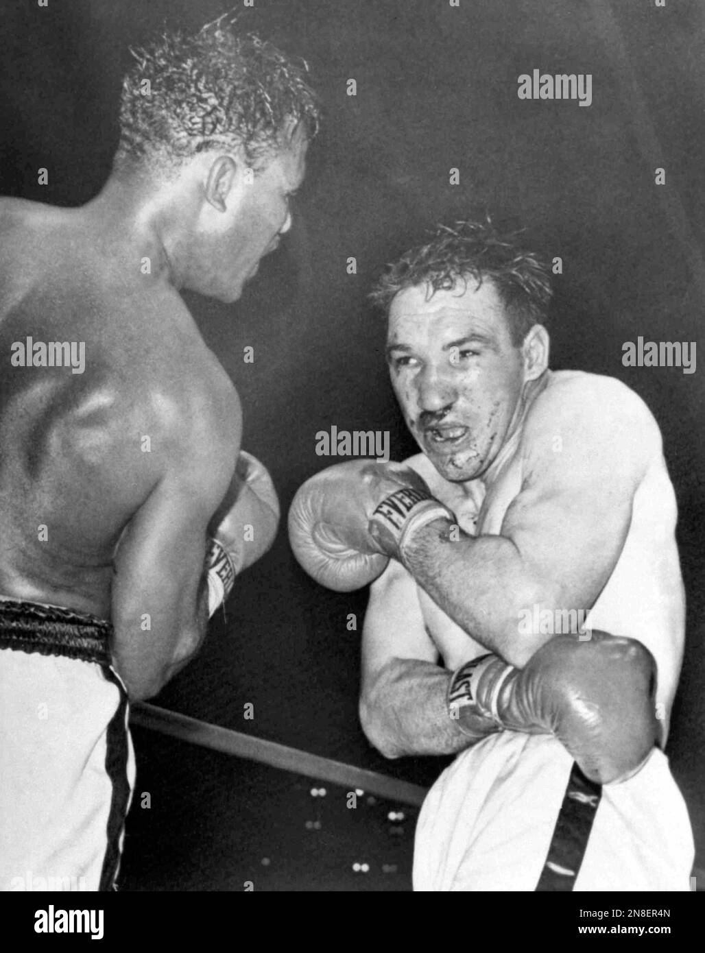 Challenger Sugar Ray Robinson, right, swings a jolting right into the ...