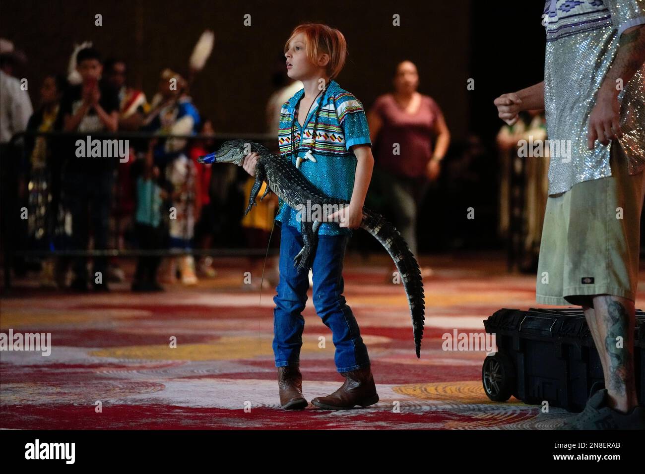 Jonah Walker, 9, son of Seminole alligator wrestler Billy Walker, holds a small alligator as he ...