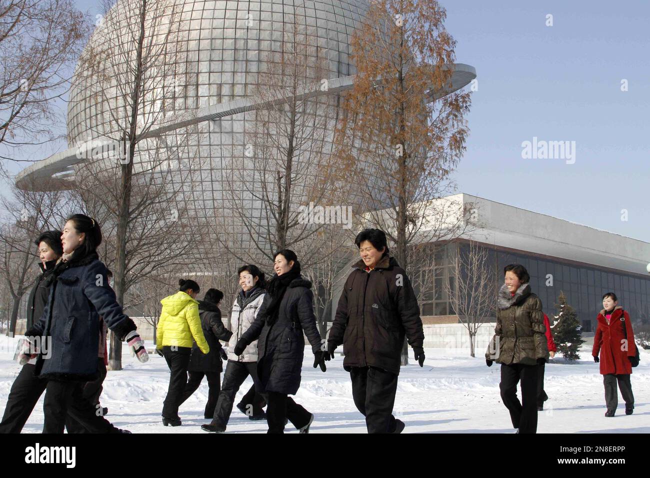 North Korean staff at the Three Revolution Exhibition Hall walk outside ...