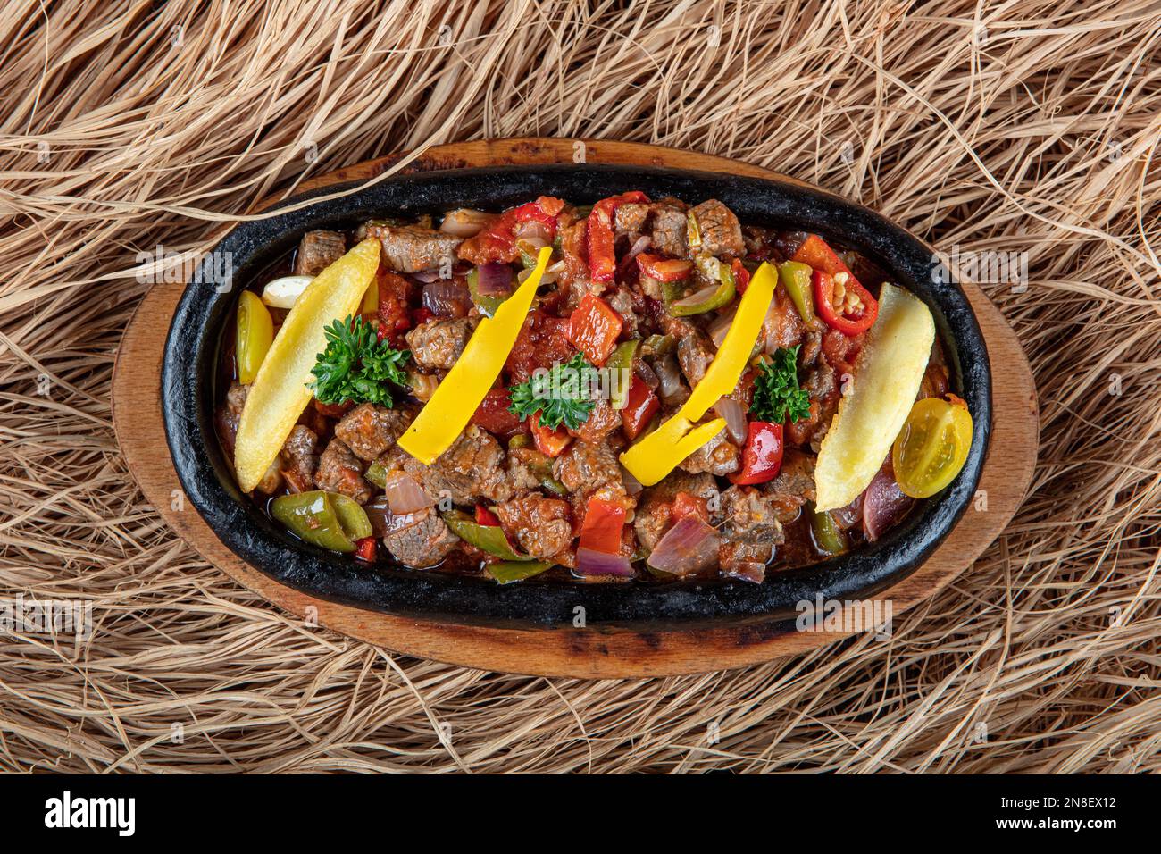 Roast meat sauteed with vegetables on wooden background.Saute meat in ...