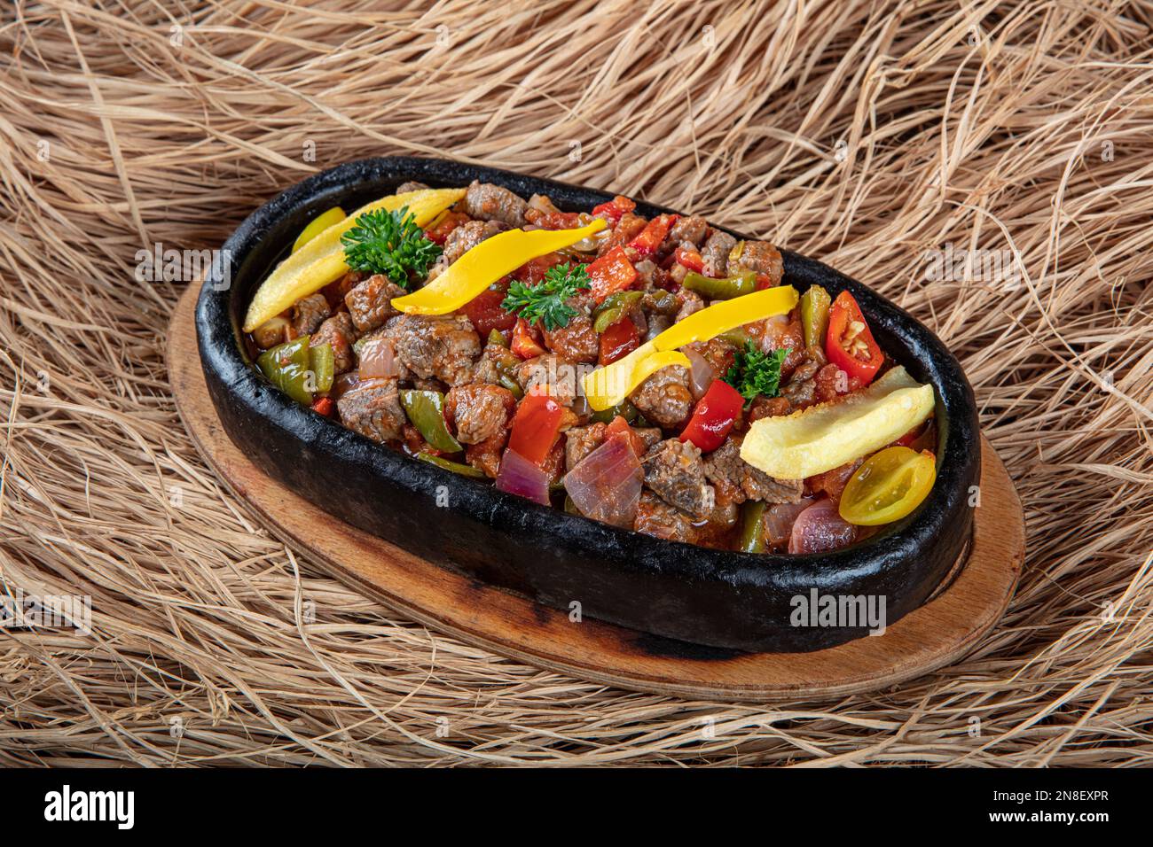 Roast meat sauteed with vegetables on wooden background.Saute meat in ...
