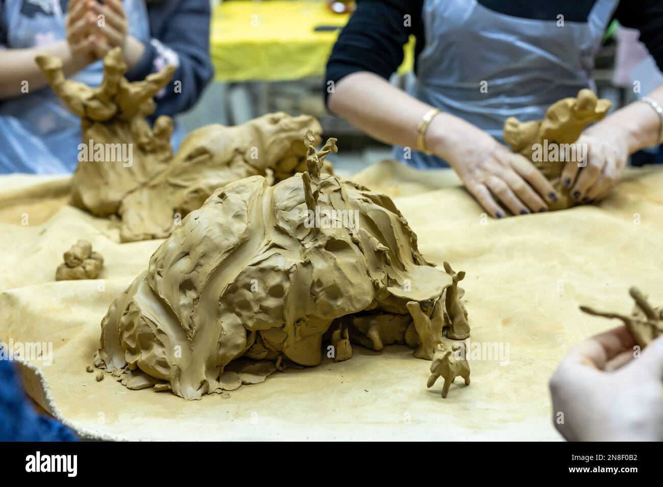 Female hands with red manicure crumple clay Stock Photo - Alamy