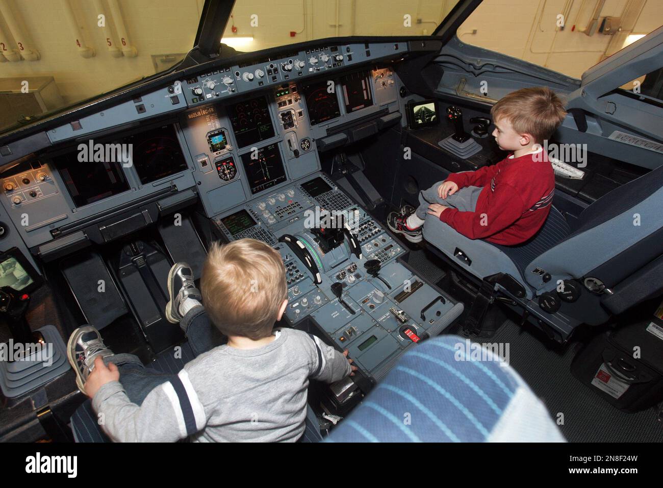 jetBlue Airways' employees' families play in the cockpit of a jetBlue ...