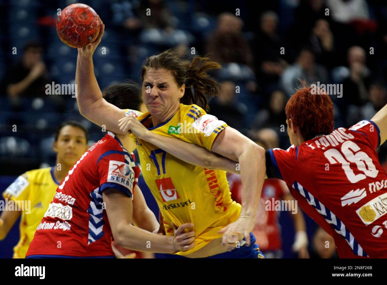 Sweden's Linnea Torstenson, center, shoots a ball between Serbia's ...