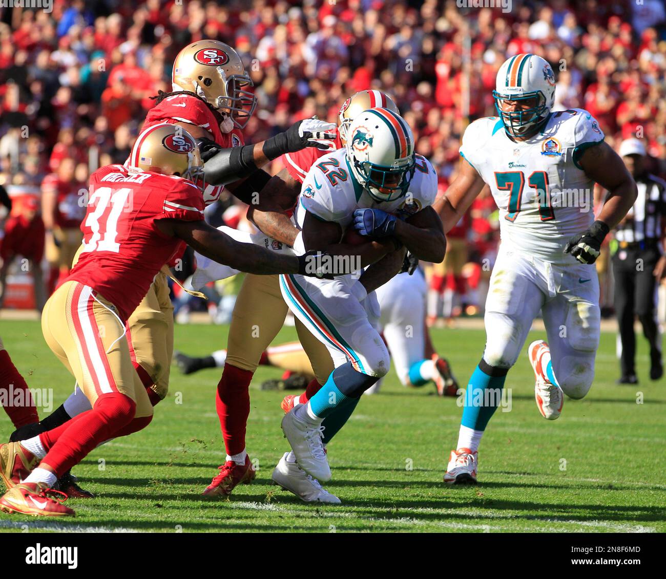 Miami Dolphins running back Reggie Bush carries the ball past San ...